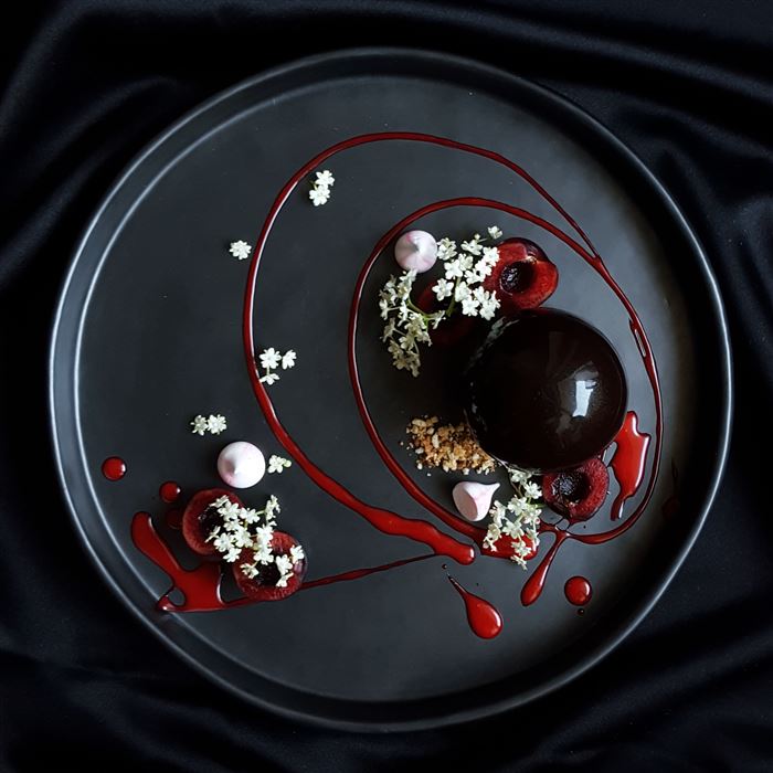 Dark chocolate mousse sphere, cherry compote, hazelnut dacquoise ...